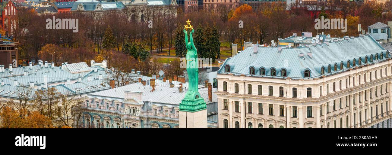The Freedom Monument in Riga, Latvia, stands tall with a statue holding ...