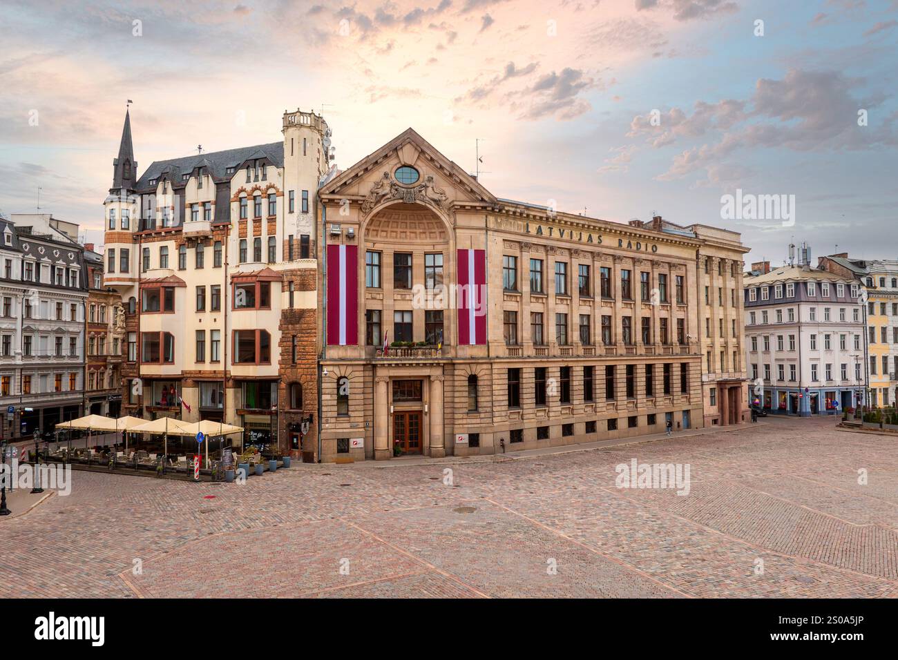An empty cobblestone square in Riga, Latvia, showcases the Latvijas ...