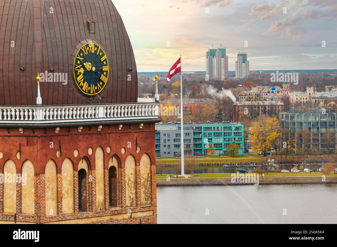 Riga Cathedral clock tower with Roman numerals, the Daugava River, and ...
