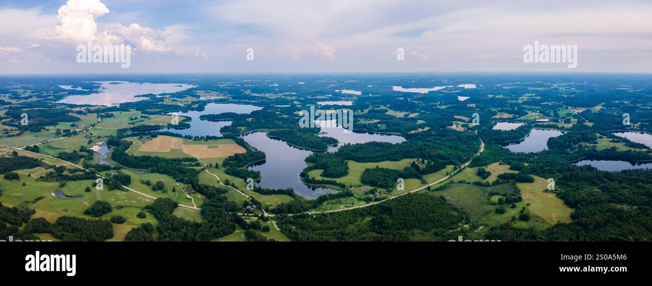 An expansive aerial view shows a rural landscape with lakes, forests ...