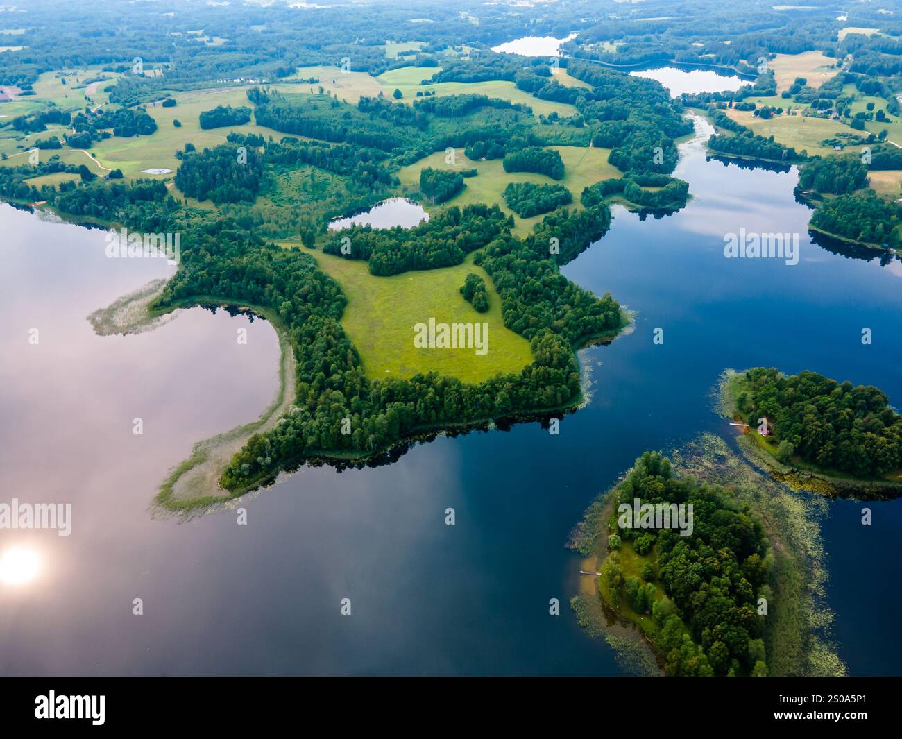 An aerial perspective reveals a lush landscape with lakes and islands ...