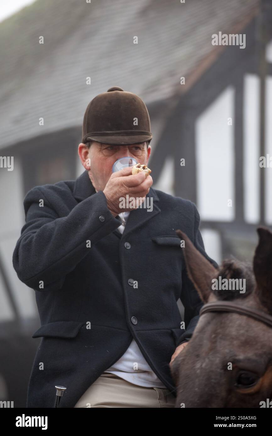 Leominster, UK. 26th Dec, 2024. A member of the hunt takes refreshment ...