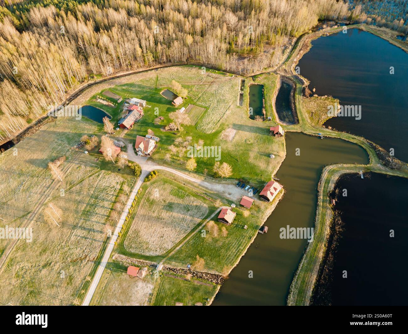 An aerial perspective shows red roof buildings amidst green fields ...