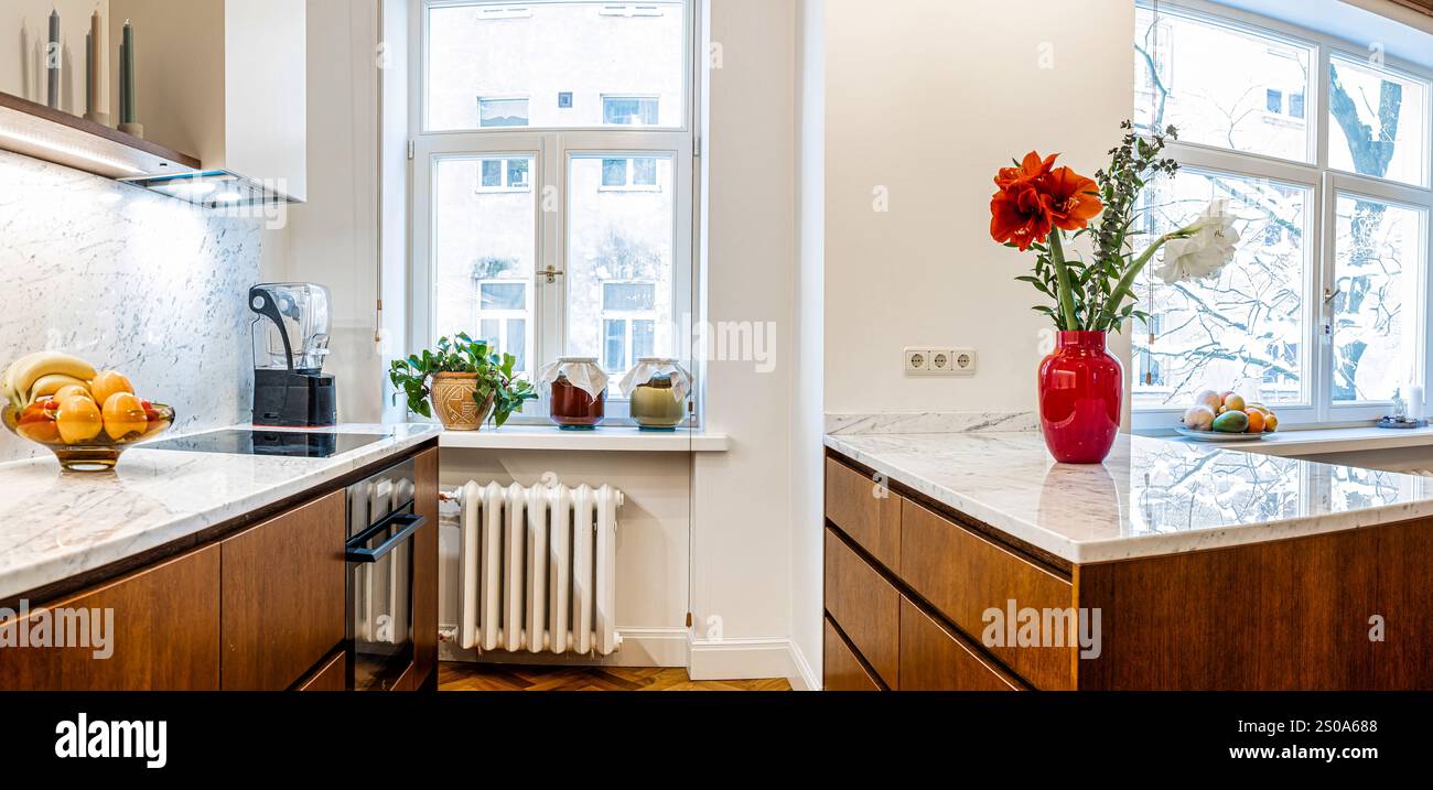 A well lit kitchen features sleek marble countertops, wooden cabinetry ...