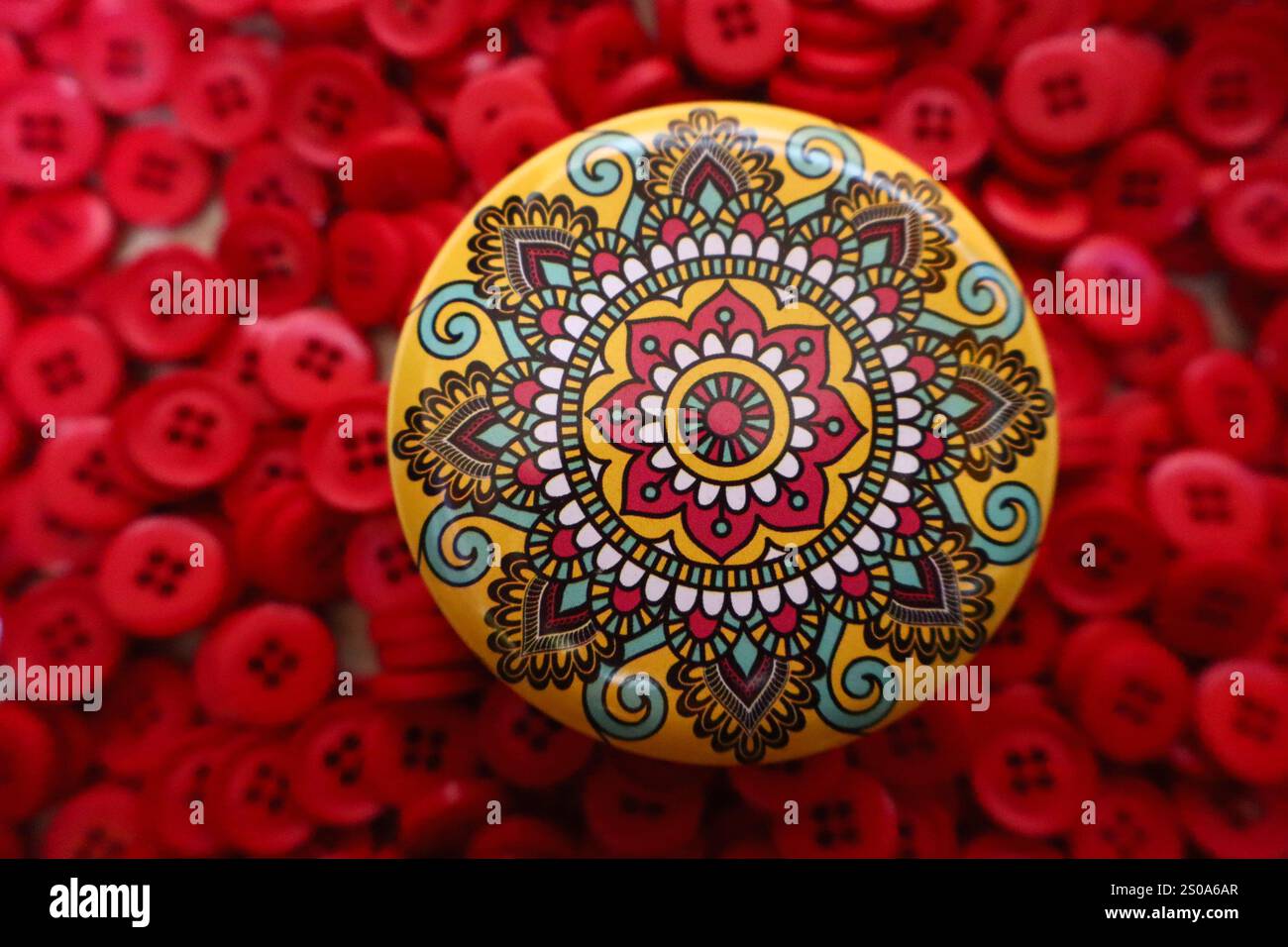 Relaxing and easy mandala design on a yellow pot with red sewing button ...