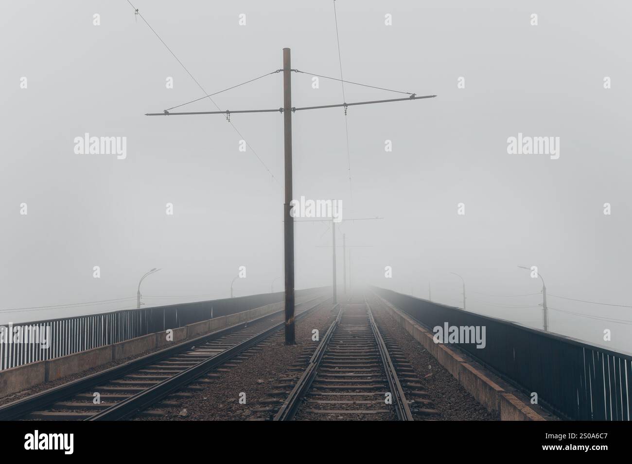 Foggy railway bridge, railroad tracks in the fog Stock Photo - Alamy