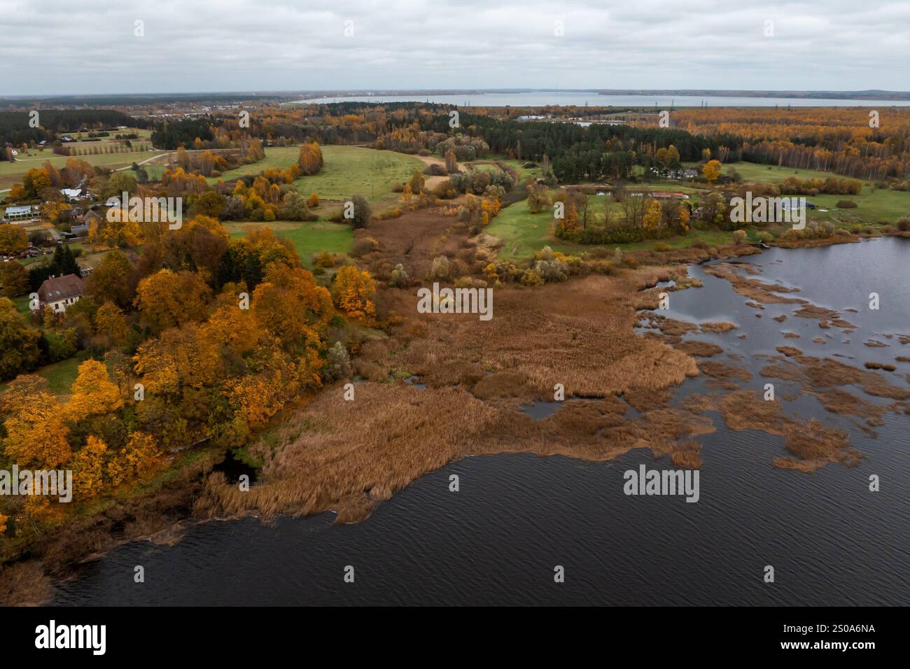 An autumn landscape features vibrant orange and yellow trees, open ...