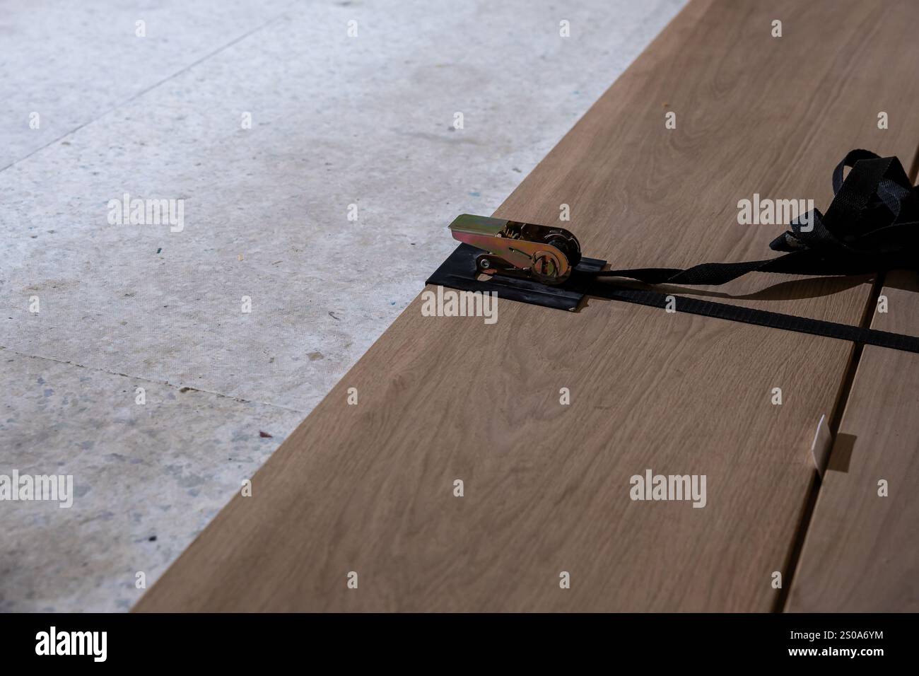 The image depicts the precise process of installing light brown wooden ...