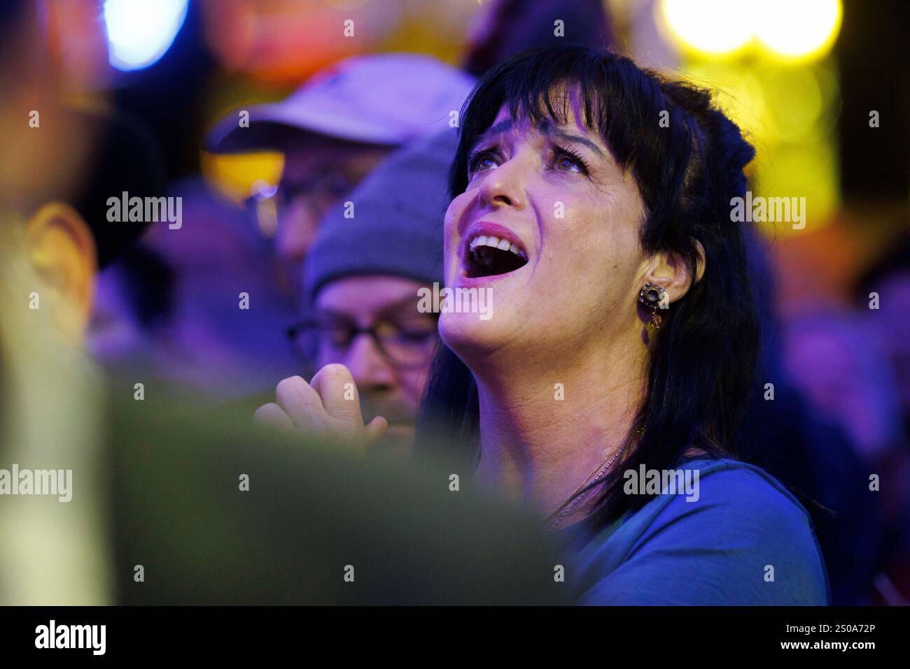 Judith Raanan looks on with joy as the Hanukah candle is lit. Hundreds ...