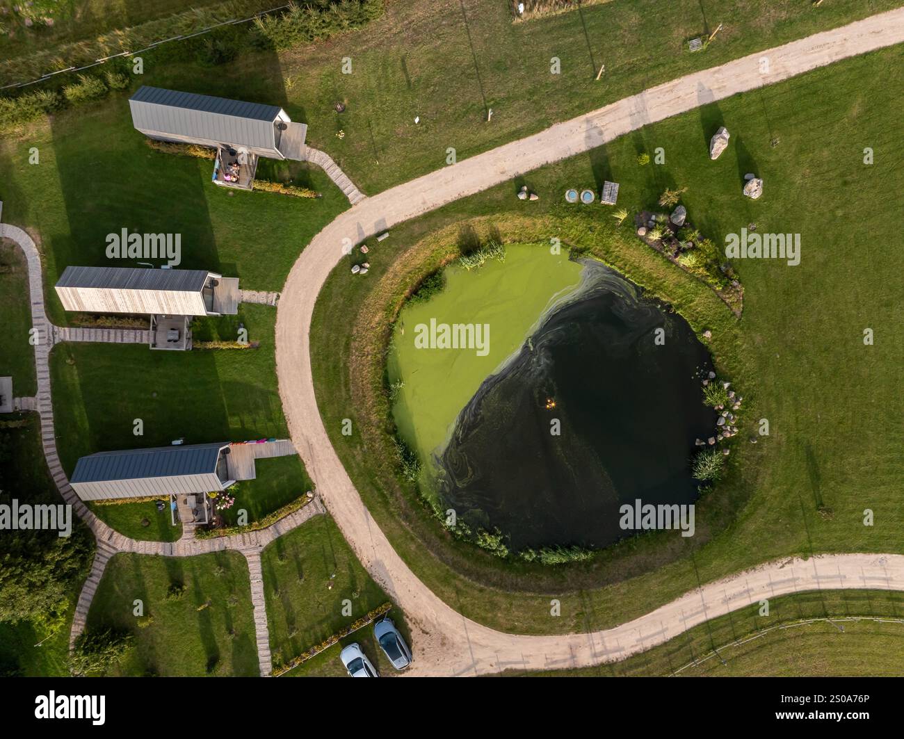 Aerial perspective of a park area with a uniquely shaped pond ...