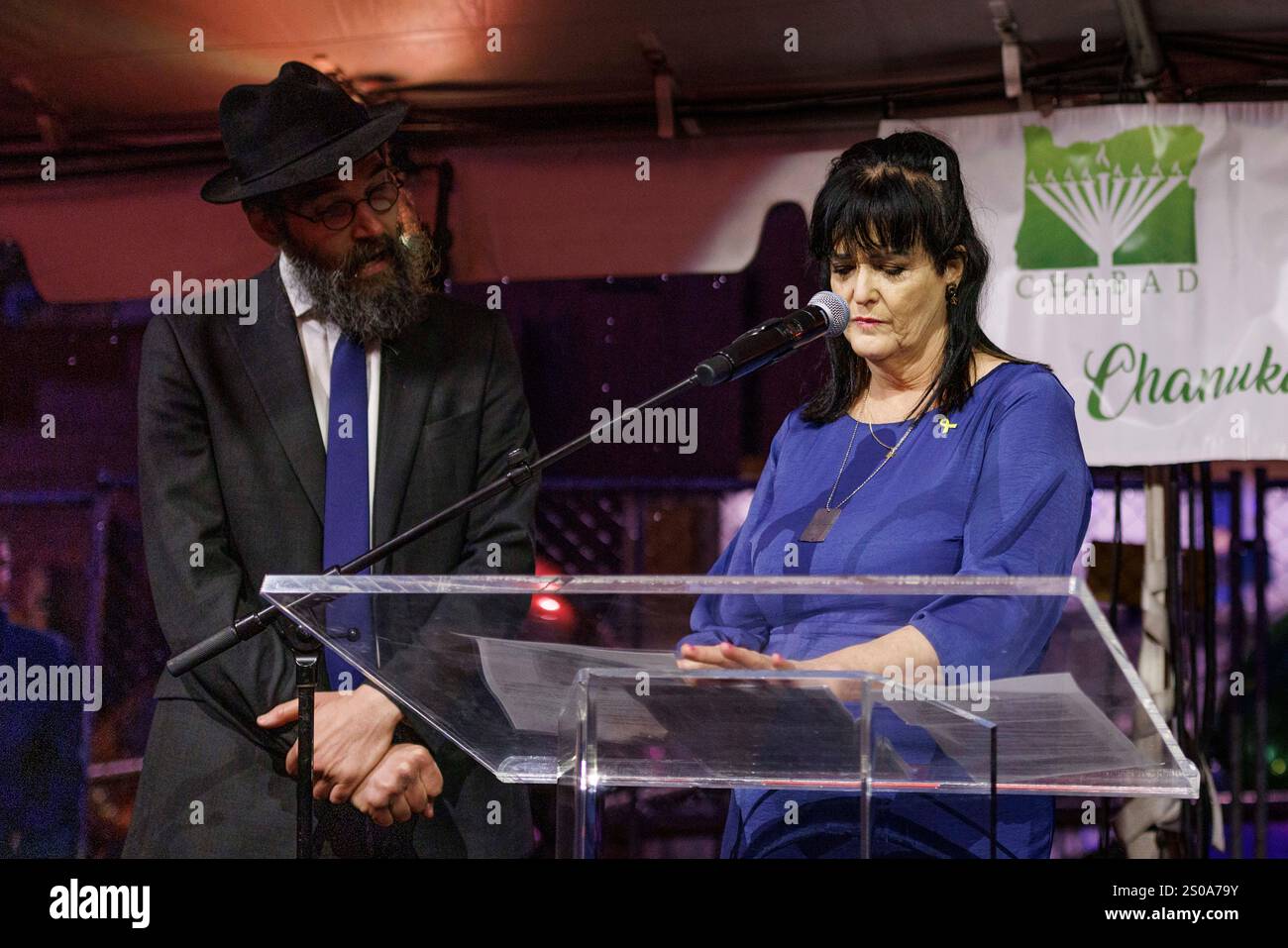 Judith Raanan speaks to the gathering. Hundreds of people celebrated ...