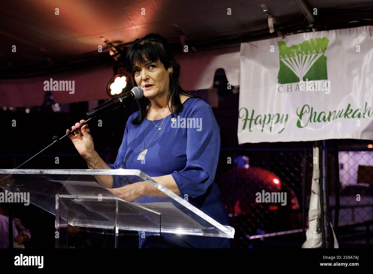 Judith Raanan speaks to the gathering. Hundreds of people celebrated ...