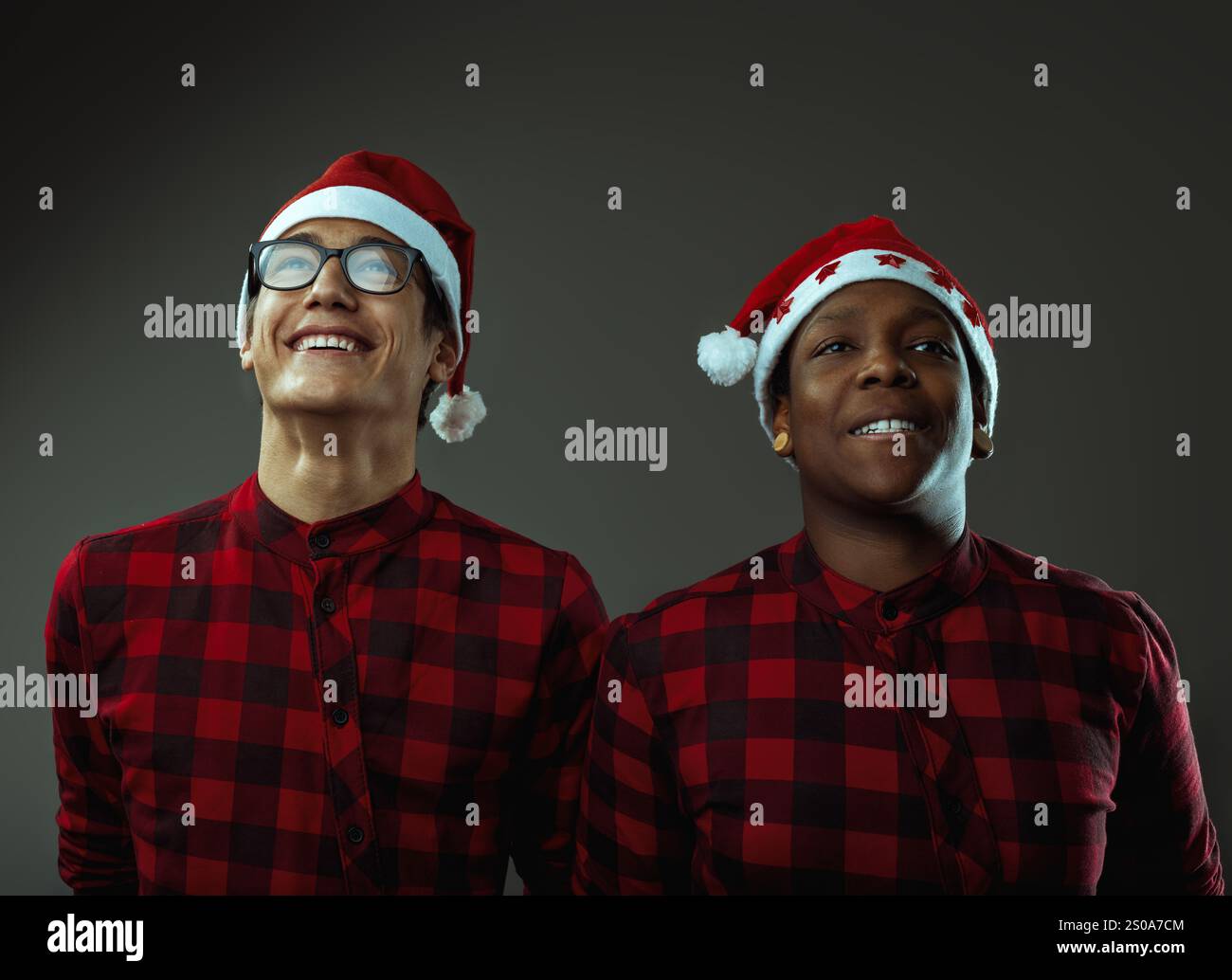 Two young adult friends with cool attitudes wearing matching red and ...