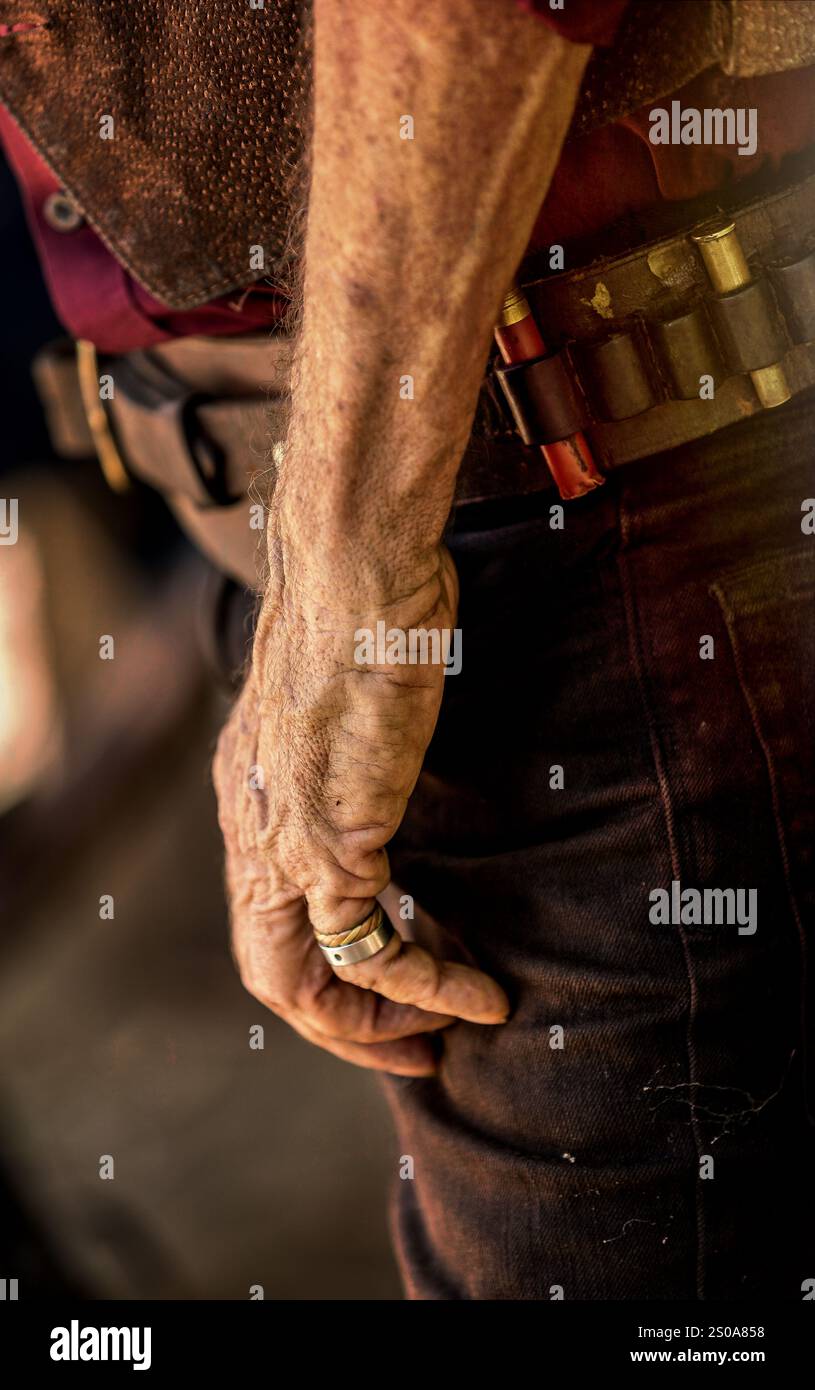 Bushman with gunbelt and bullets / hand study Stock Photo - Alamy