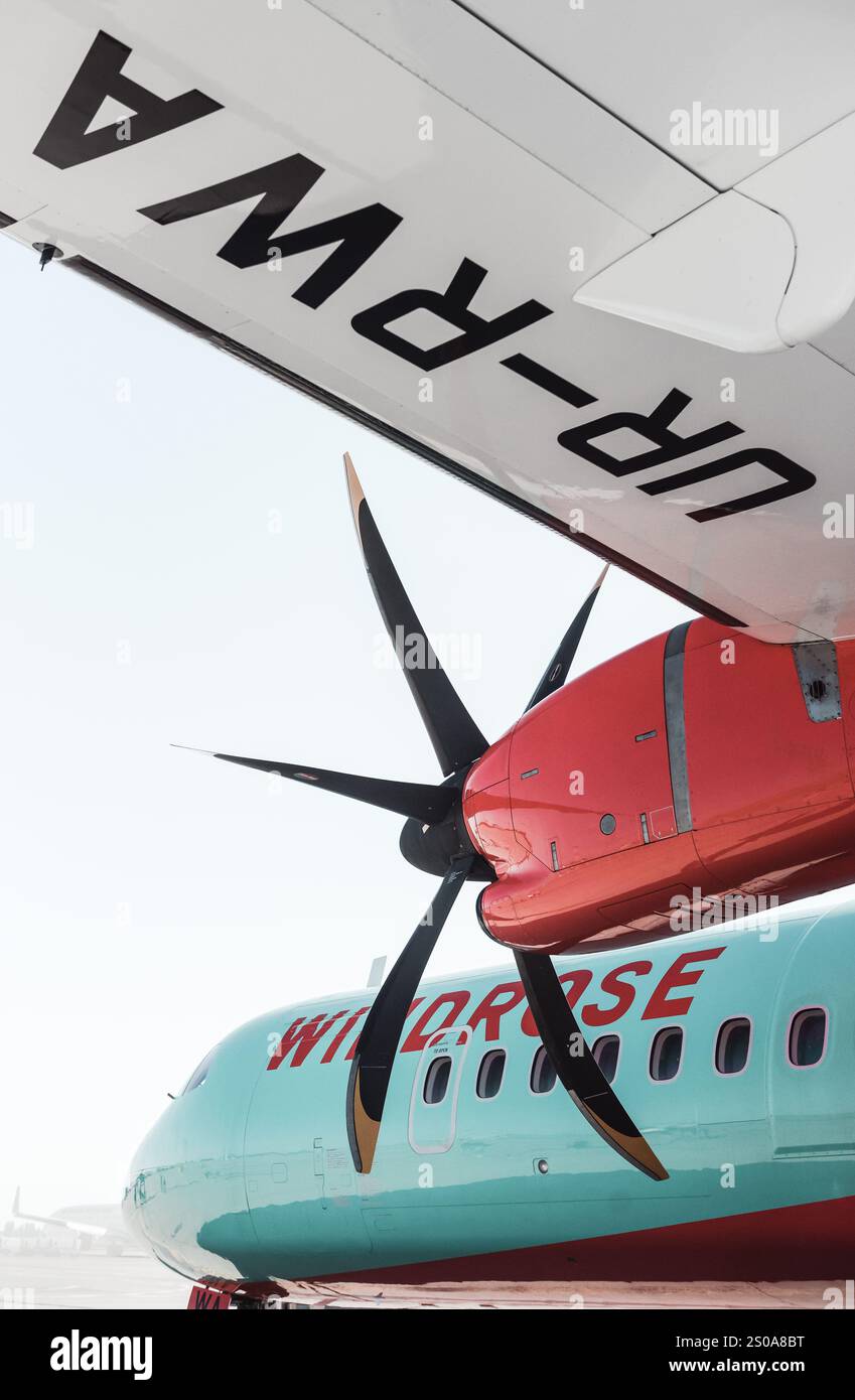 Windrose ATR-72 regional airliner - view from under a wing. Turquoise ...