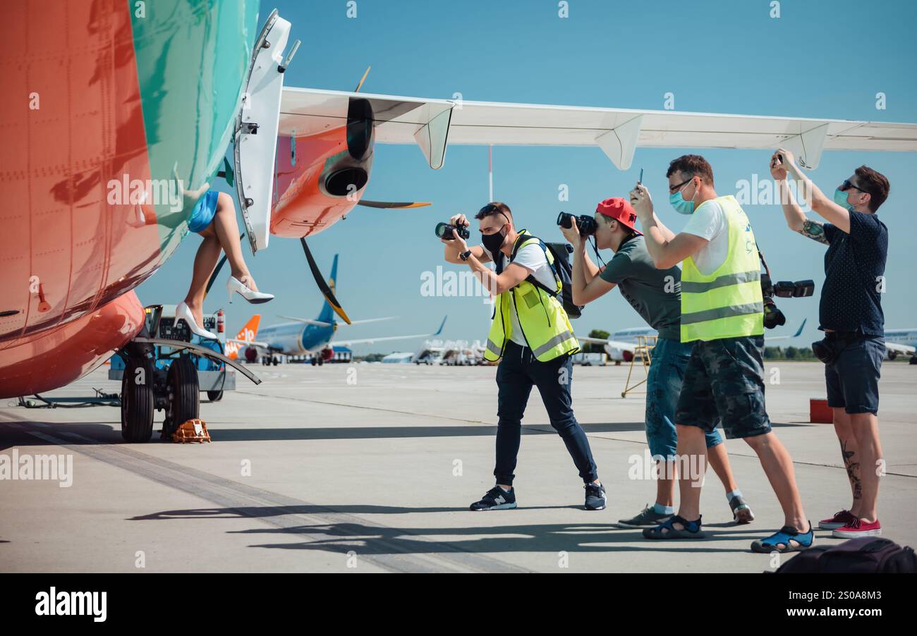 Group of plane spotters and reporters taking pictures of flight ...