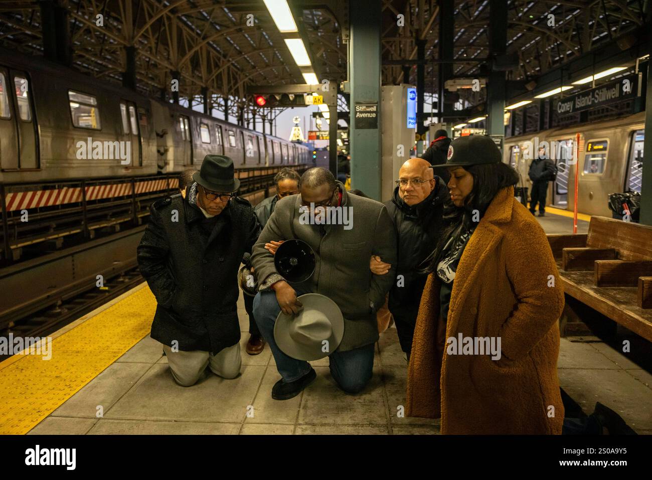 Rev. Kevin McCall, second from left, and community leaders pray on the ...