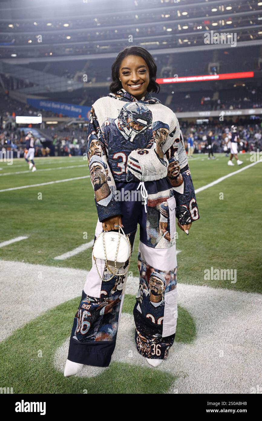 Simone Biles poses for a photo before an NFL football game between the ...