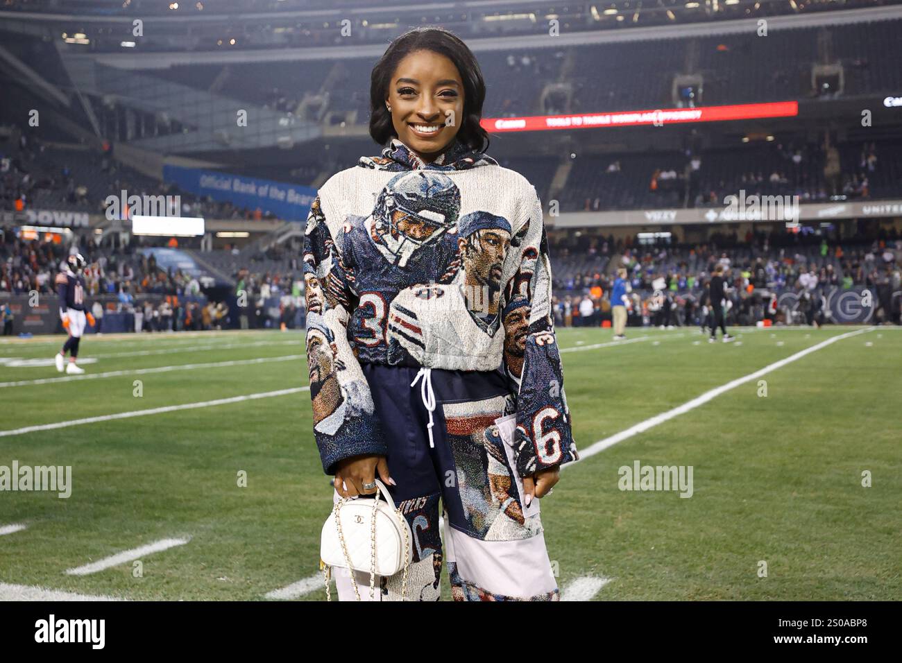 Simone Biles poses for a photo before an NFL football game between the ...