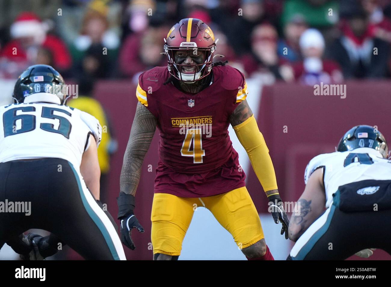 Washington Commanders linebacker Frankie Luvu (4) eyes the passer ...