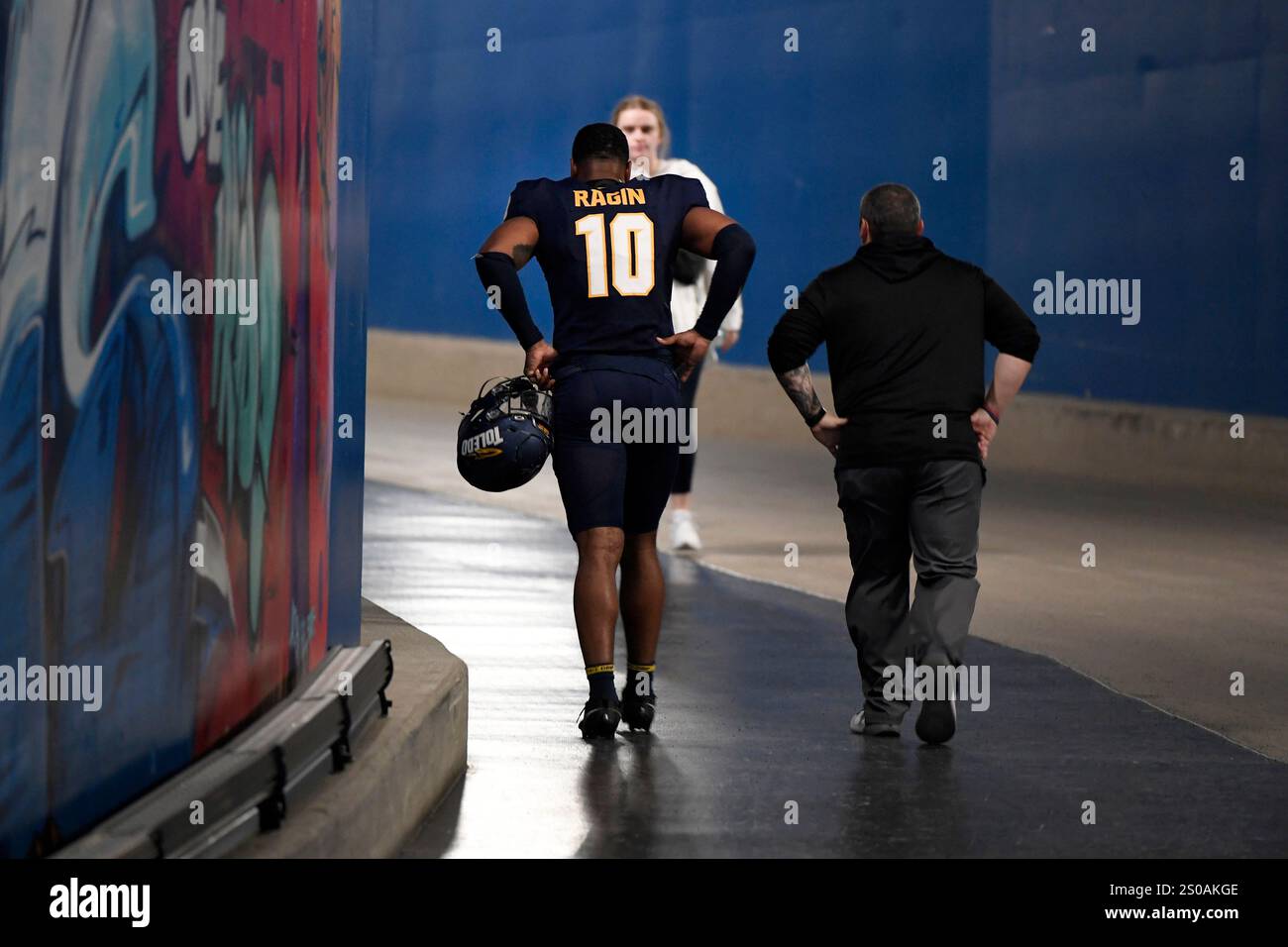 Toledo defensive end D'Andre Ragin (10) is escorted away after he was ...