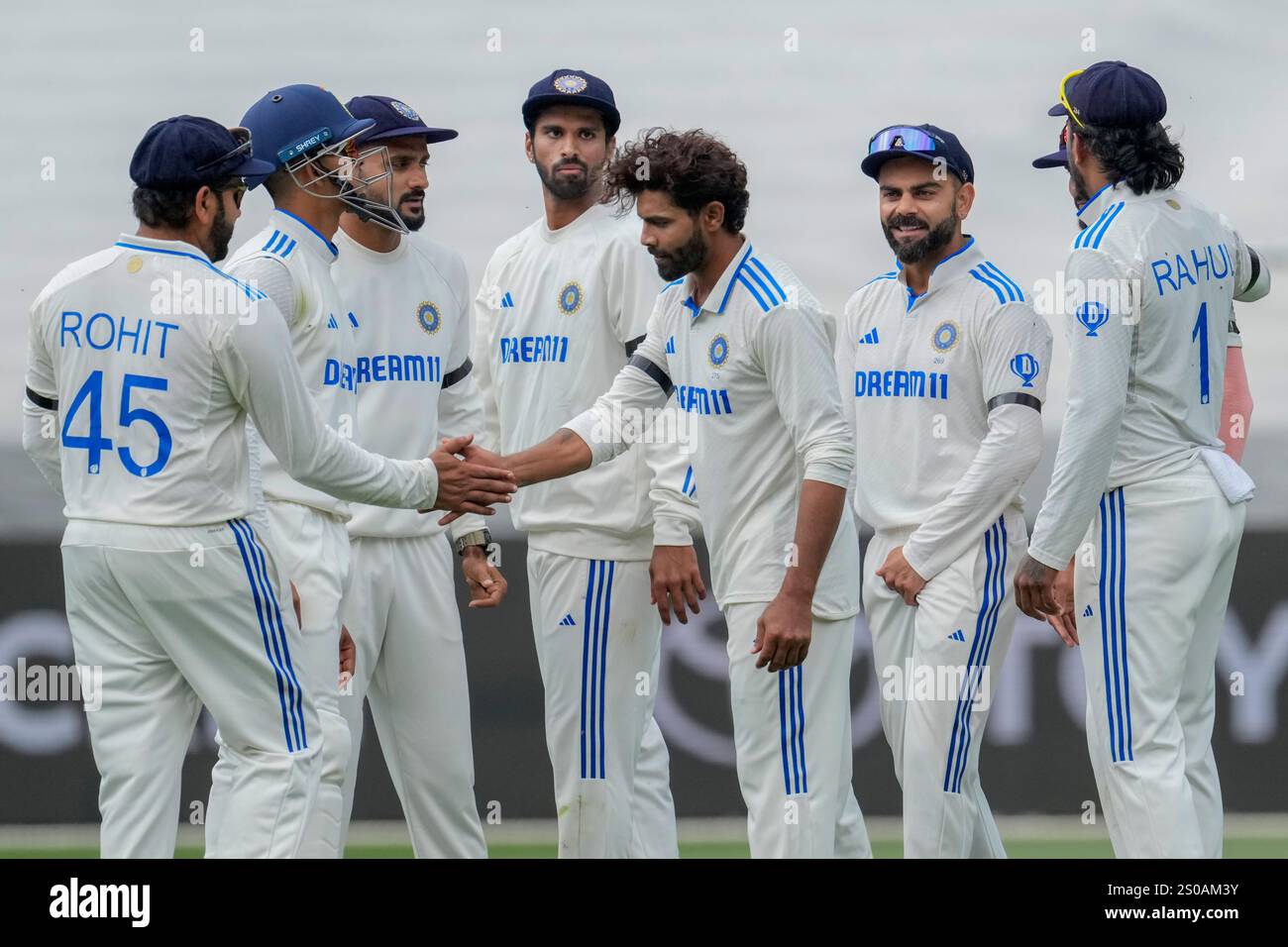 India's Ravindra Jadeja, center without cap, celebrates with teammates ...