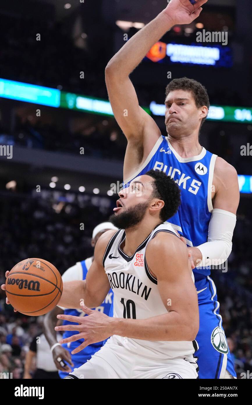 Brooklyn Nets' Ben Simmons looks to shoot past Milwaukee Bucks' Brook ...