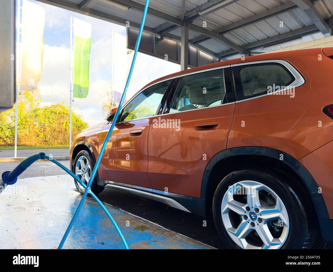 Paris, France - Nov 20, 2024: A BMW iX1 is being washed at a self ...