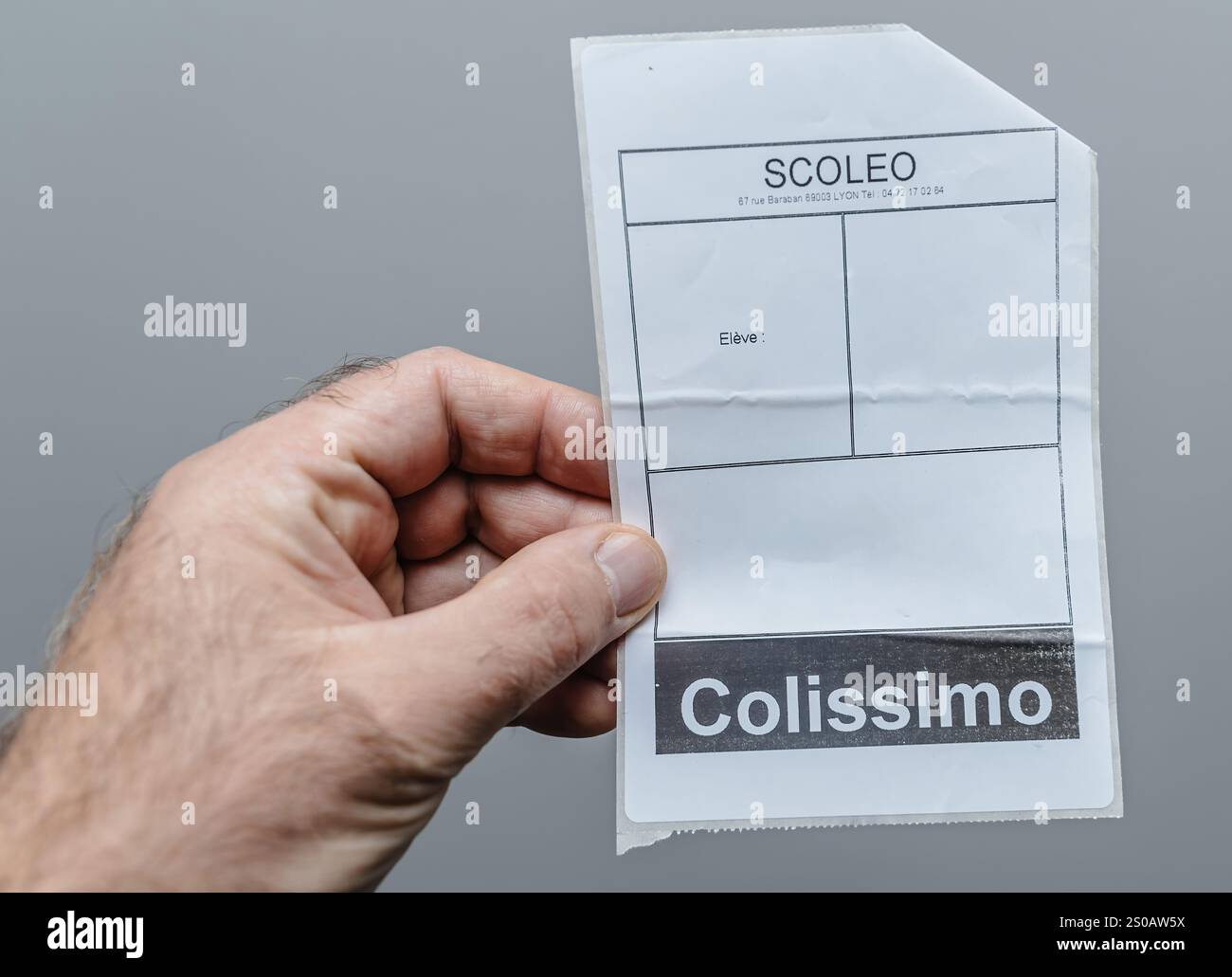 Paris, France - Oct 25, 2023: Hand holding a Colissimo shipping label ...