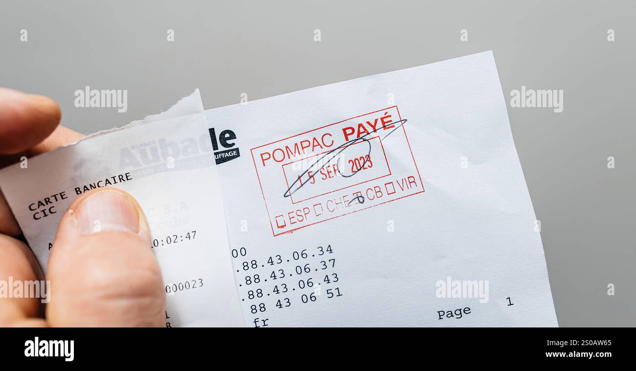 Paris, France - Oct 25, 2023: Hand holding a receipt from Espace Aubade ...