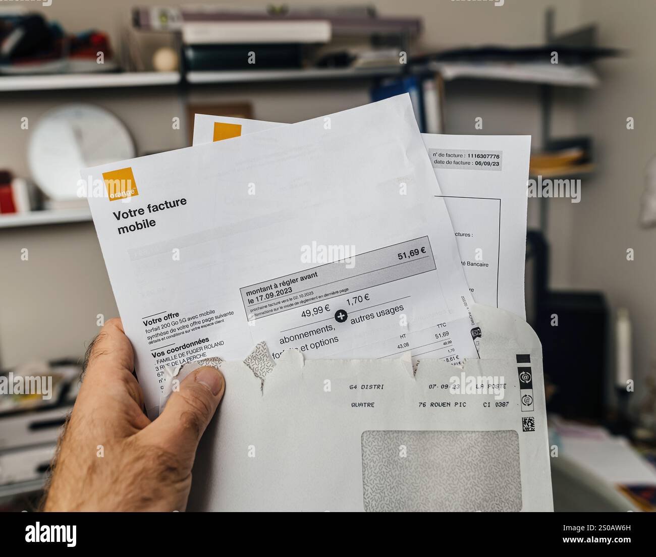 Paris, France - Oct 25, 2023: Hand holding an Orange mobile service ...