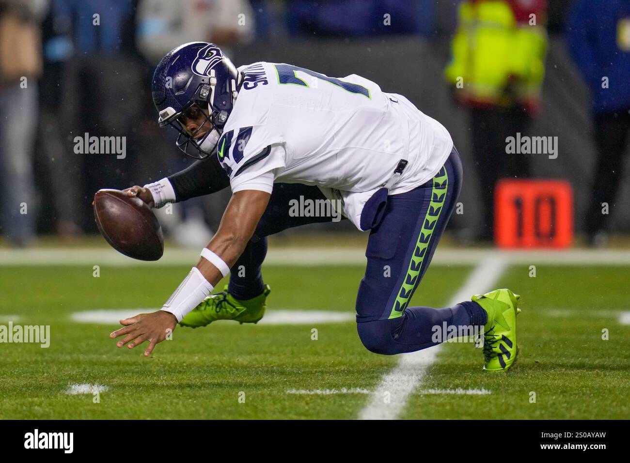 Seattle Seahawks quarterback Geno Smith slips while rolling out against ...