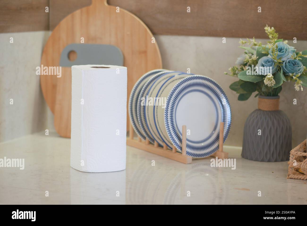 Simple Kitchen Countertop With White Roll, Dish Rack, and Floral ...