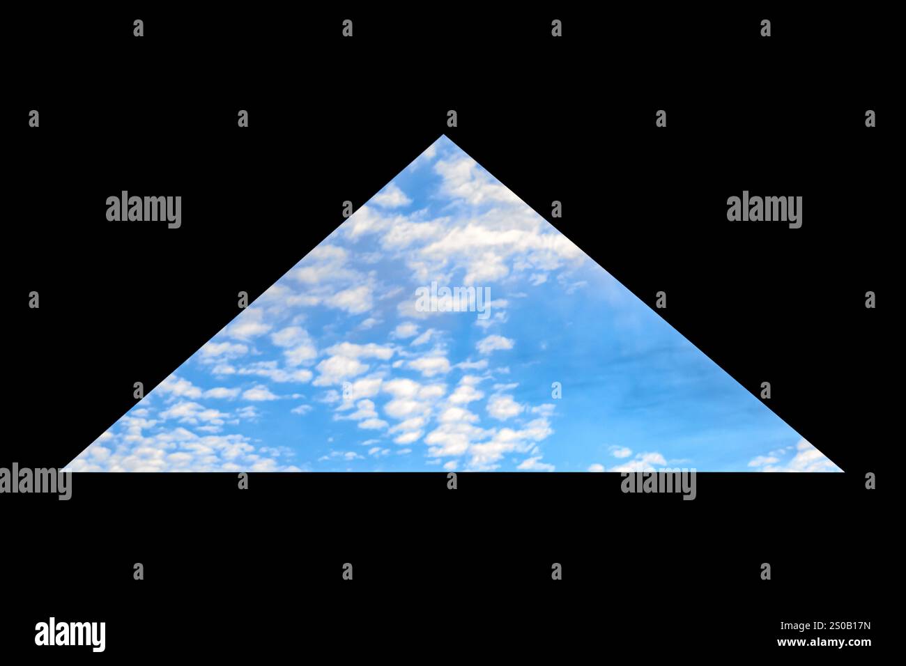 A right-angled triangular window open to a blue sky and puffy white ...