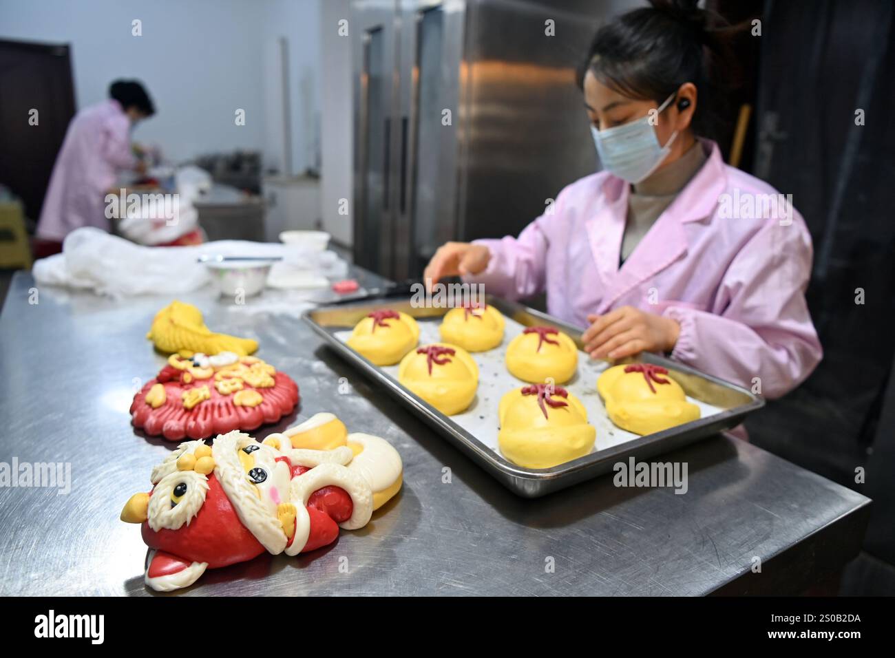 Lanzhou,China.26th December 2024. Pastry chefs make Chinese snake ...