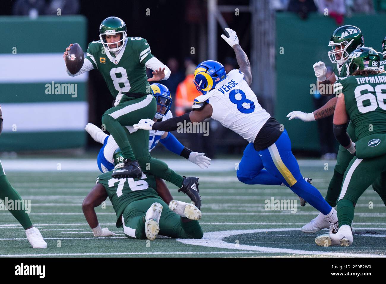New York Jets quarterback Aaron Rodgers (8) leaps over offensive ...
