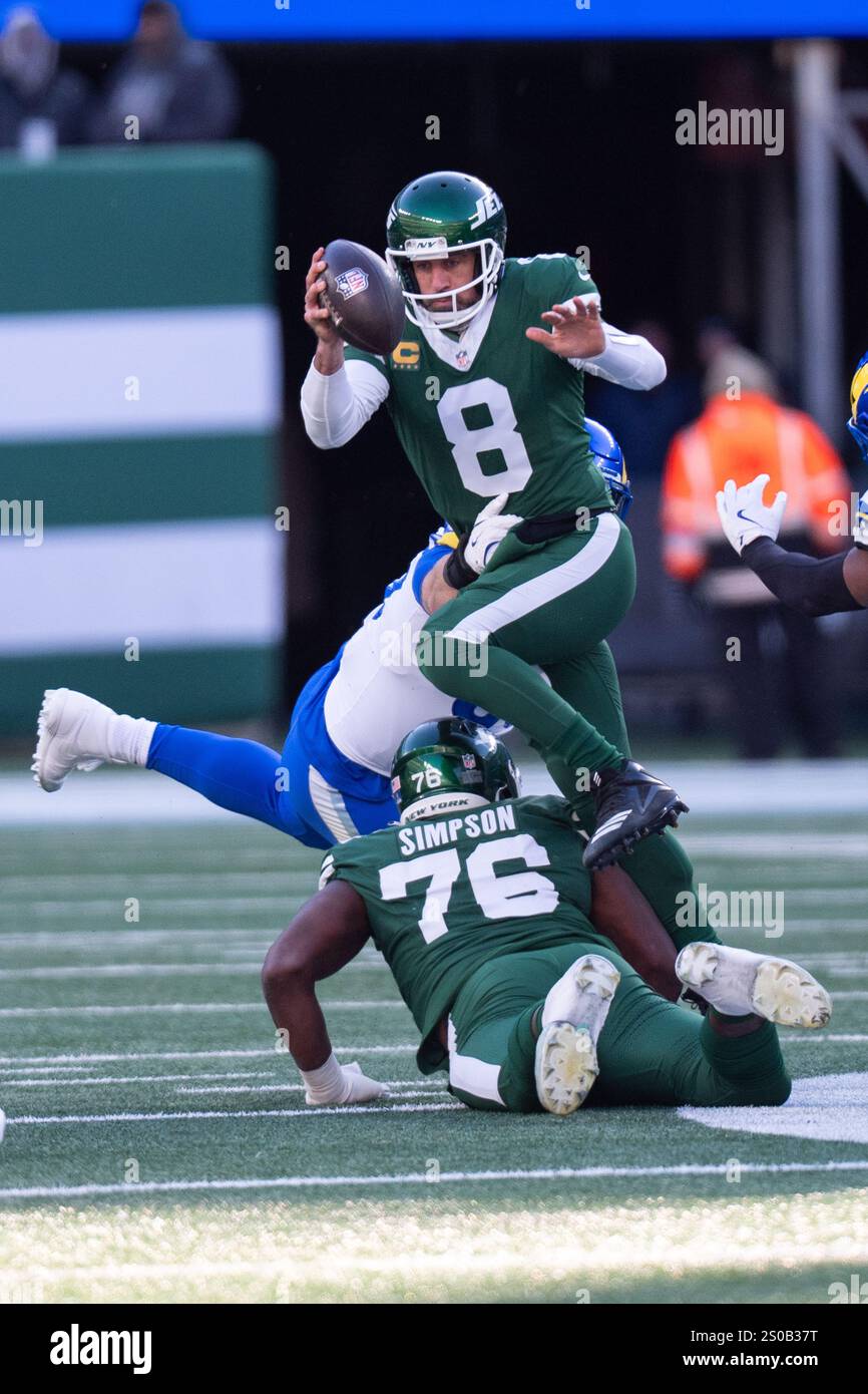 New York Jets quarterback Aaron Rodgers (8) leaps over offensive ...