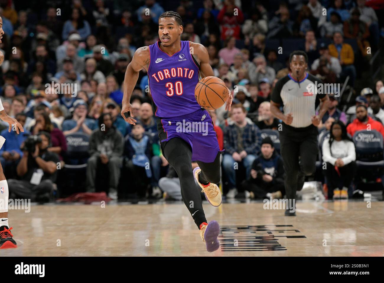 Toronto Raptors guard Ochai Agbaji (30) brings the ball up court in the ...