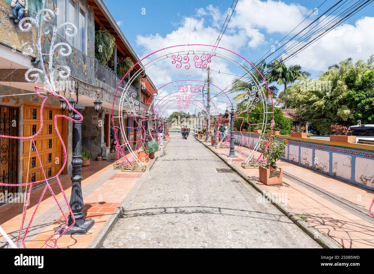 Festive street scene adorned with charming light displays. A ...