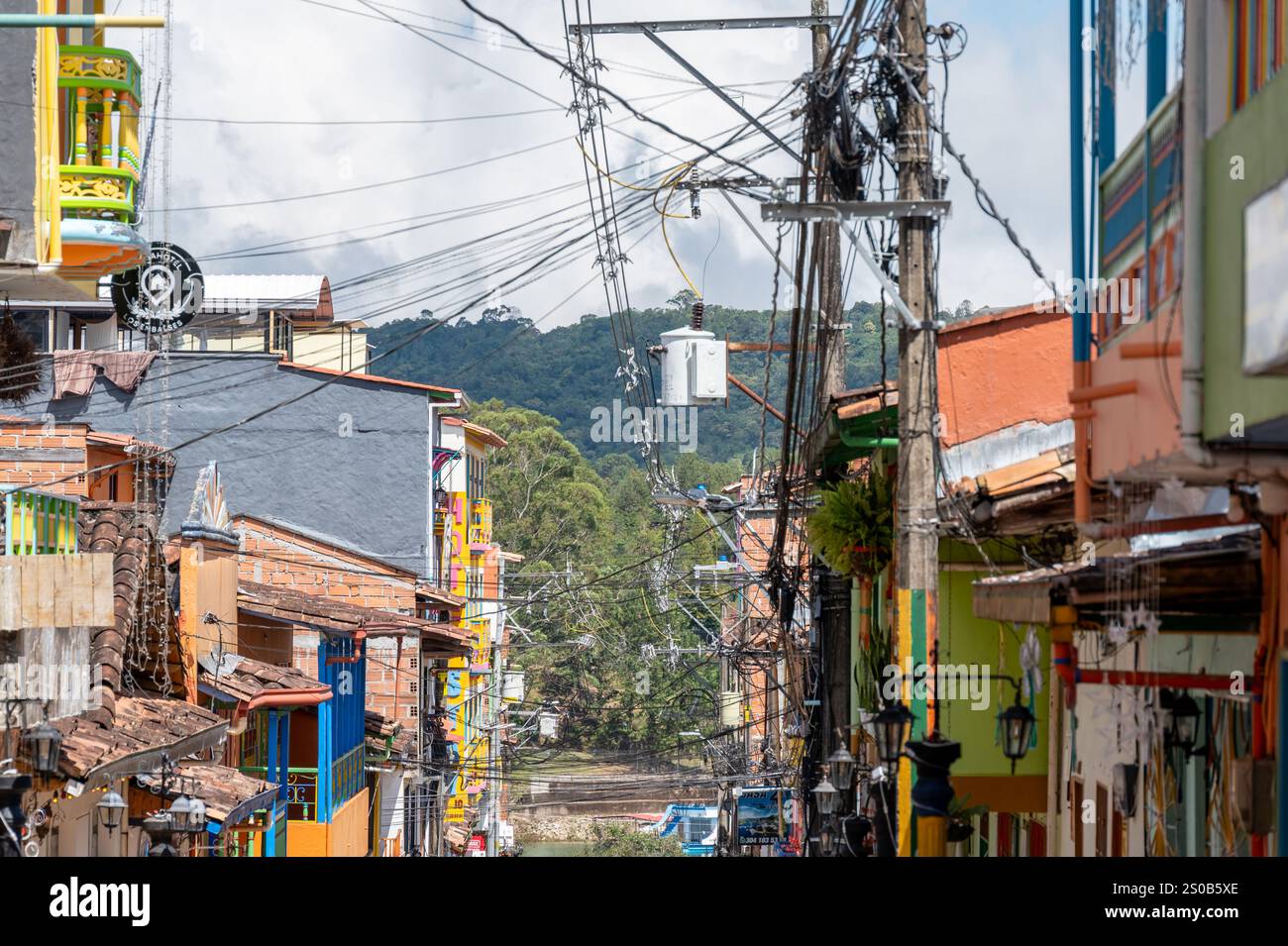 Vibrant street scene nestled amongst lush hills. A colorful display of ...