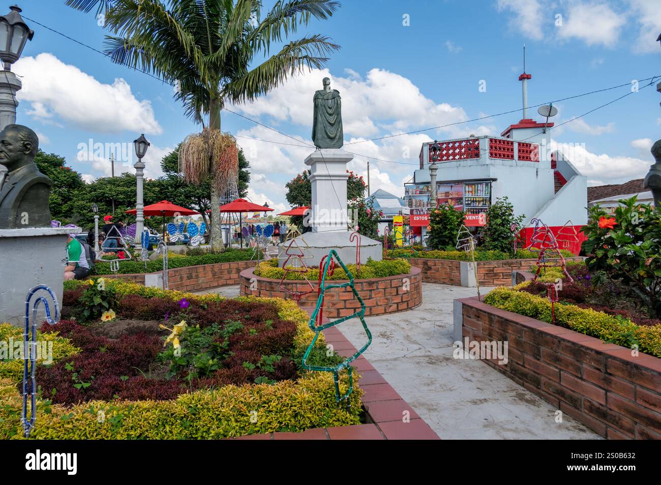 A vibrant town square, adorned with lush greenery and festive ...