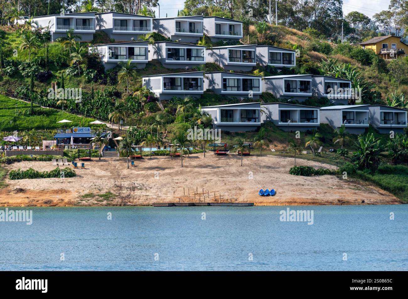 Lakeside luxury. Modern villas nestled on a hillside overlooking ...