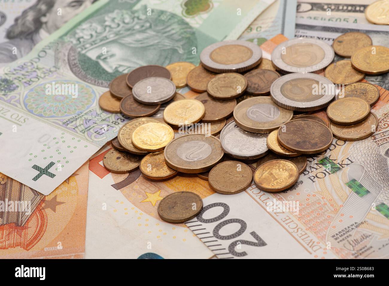 A pile of coins and bills including a 50 dollars bill. The coins are of ...