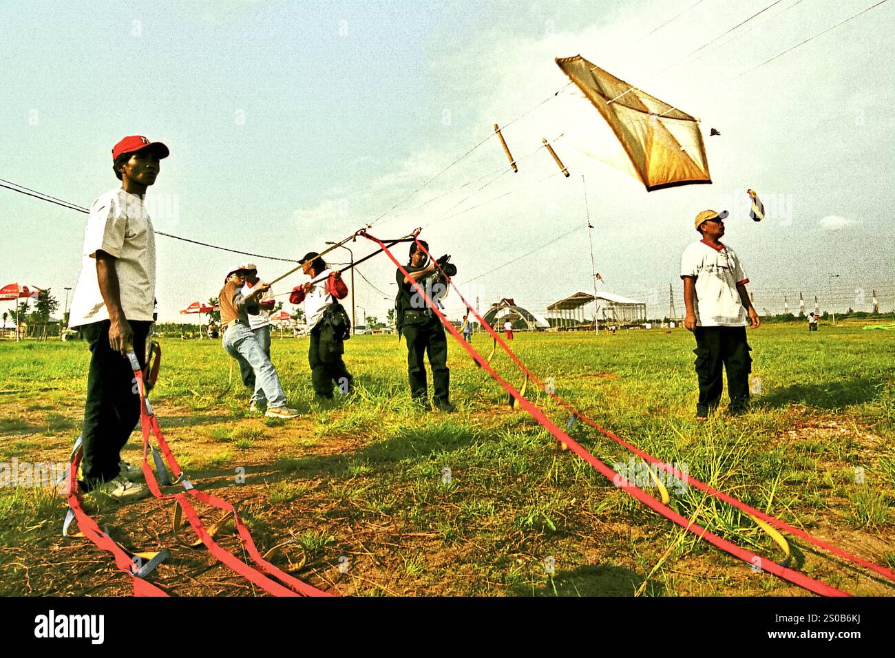 Men flying kite during the 2004 Jakarta International Kite Festival ...