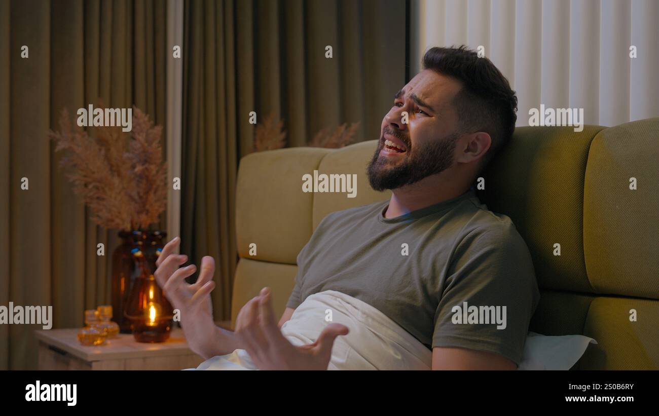 Frustrated man sitting bed screaming despair loss failure divorce ...