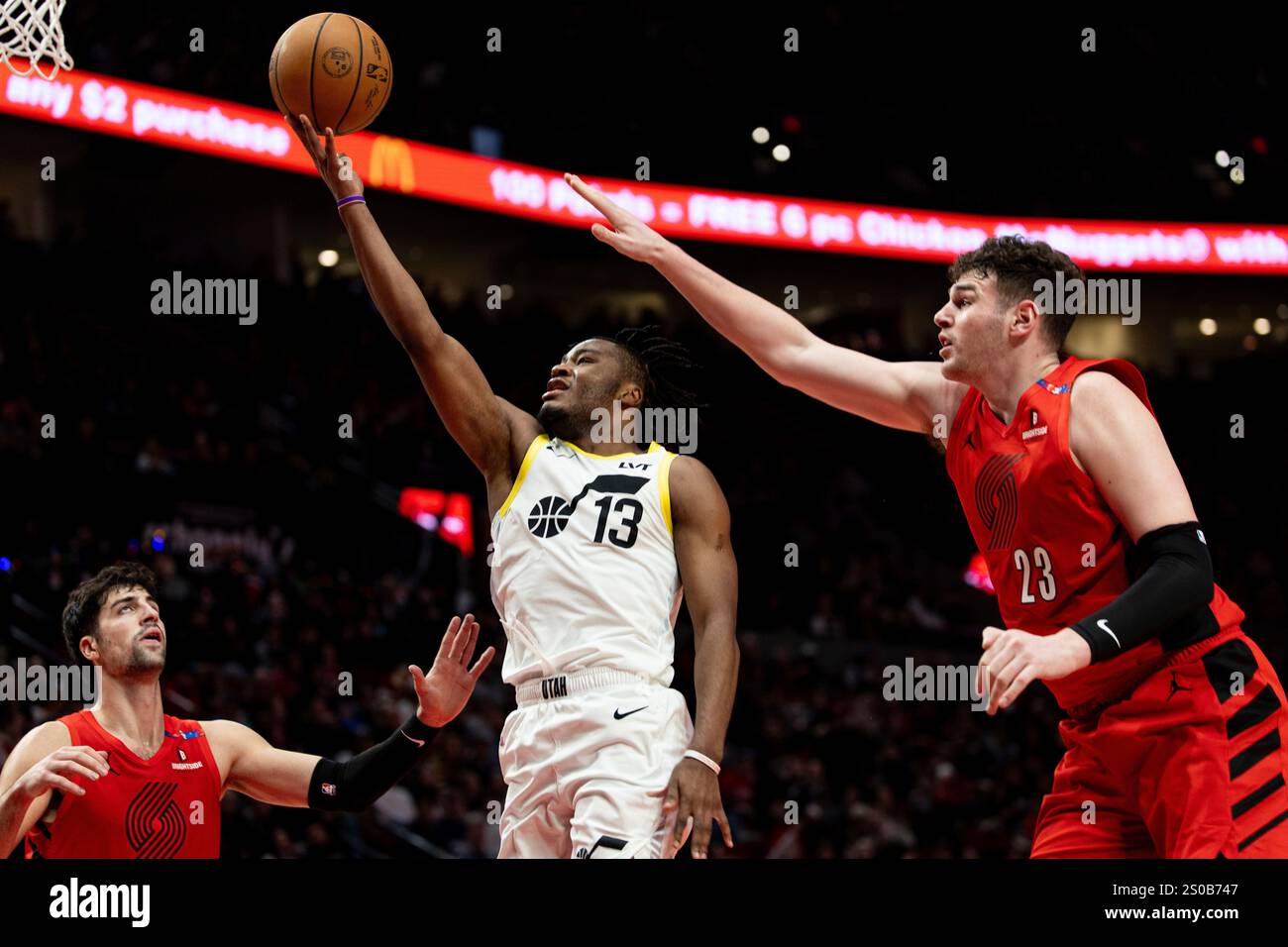 Utah Jazz guard Isaiah Collier, middle, drives to the hoop against ...