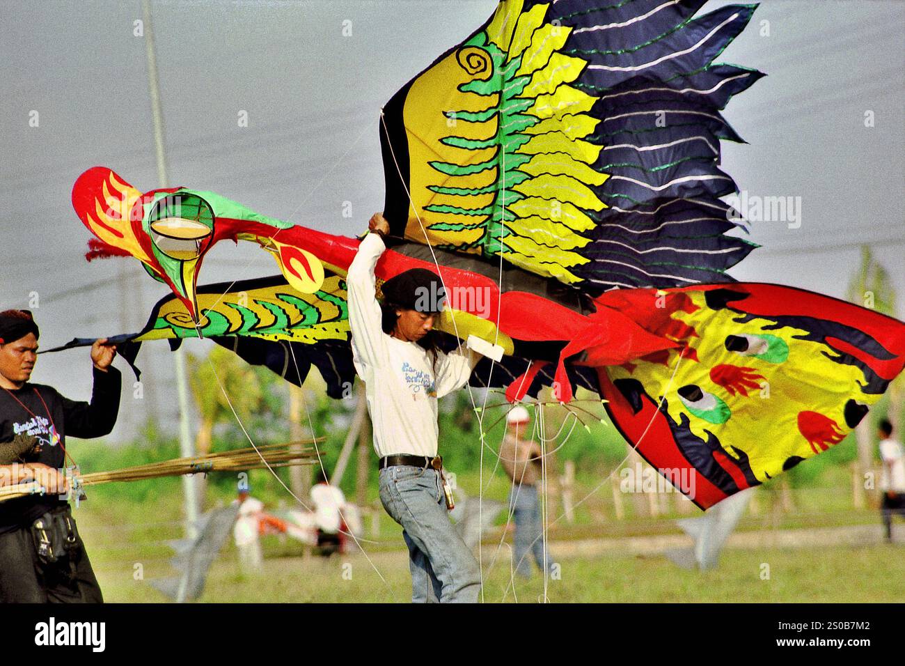 A participant transporting a giant kite that was designed to represent ...