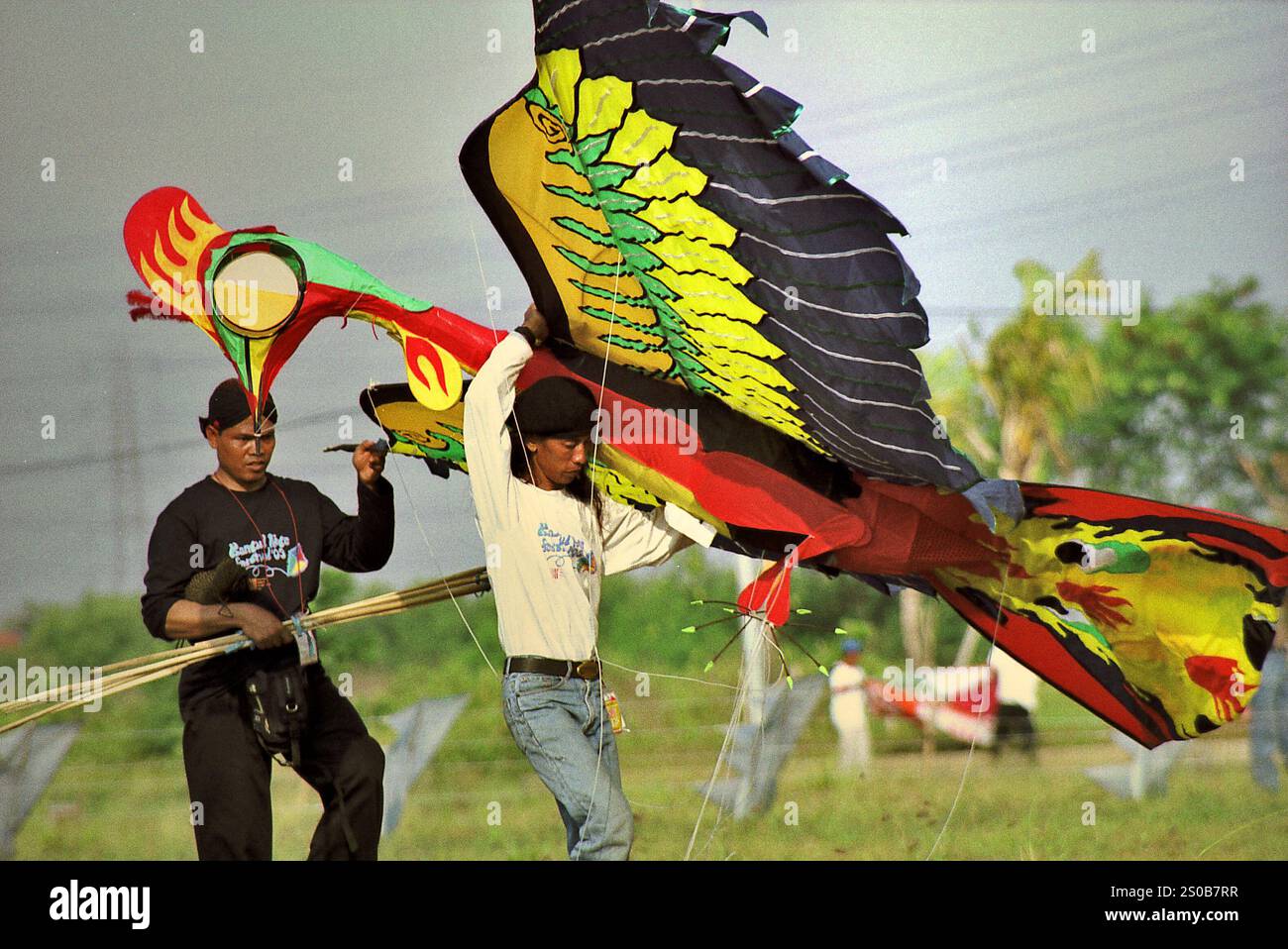 A participant transporting a giant kite that was designed to represent ...