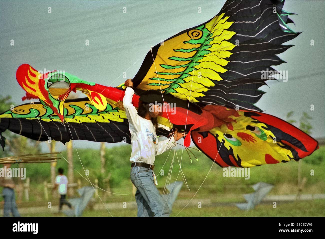 A participant transporting a giant kite that was designed to represent ...