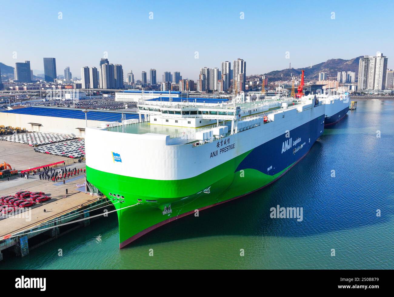 A roll on/roll off ship is loading export vehicles at an export ...